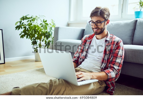 Young Relaxed Student Working On Laptop Foto stock 695084809 | Shutterstock