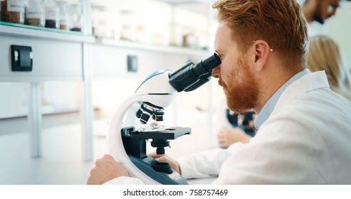 Young Scientist Looking Through Microscope Laboratory Foto stock 758757469 | Shutterstock