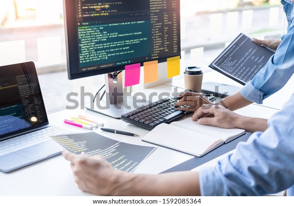 Young Startup Programmers Sitting Desks Working foto stock 1592085364 ...