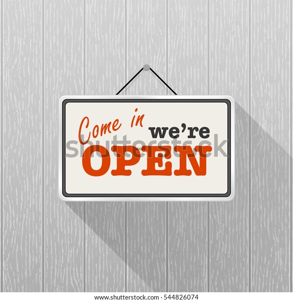 Simple white sign with text 'Come in we're open' hanging on a gray ...