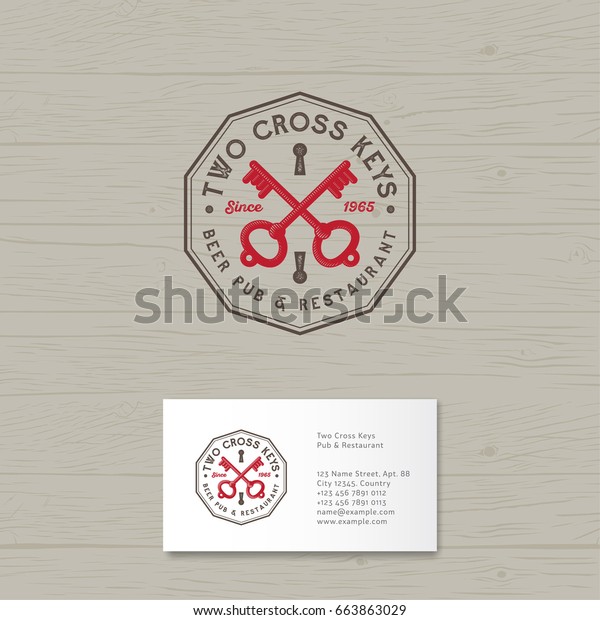 Two cross keys pub logo. Two keys with letters emblems on a wood ...