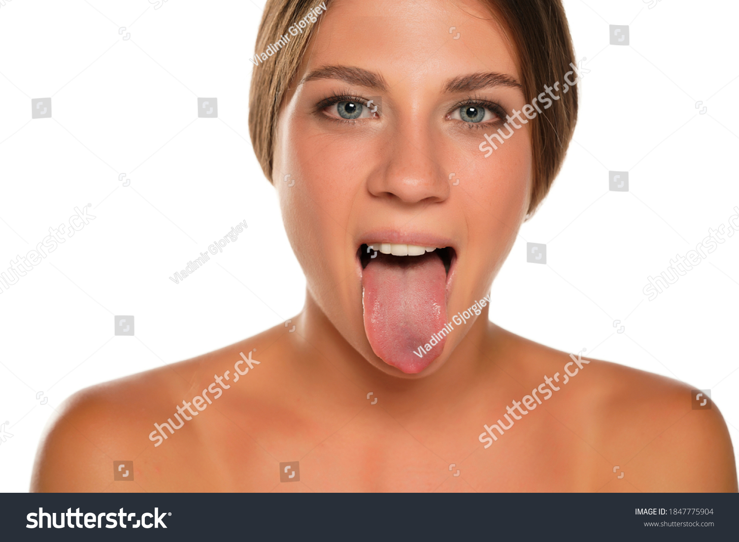 Photo De Stock Jeune Belle Femme Sortant Sa Langue 1847775904