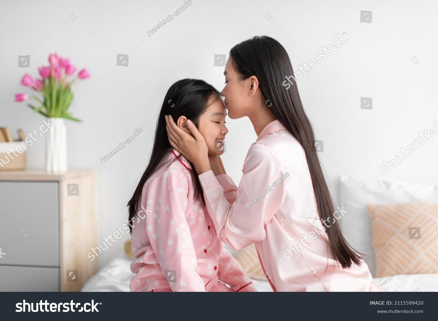 Cheerful Japanese Millennial Female Kissing Forehead Stock Photo ... Cheerful Japanese Millennial Female Kissing Forehead Stock Photo ...