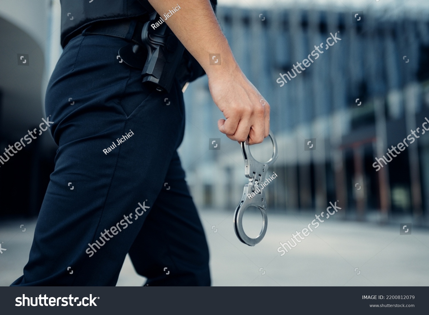 Police Officer Hand Holding Handcuffs Stock Photo 2200812079 | Shutterstock Police Officer Hand Holding Handcuffs Stock Photo 2200812079 | Shutterstock
