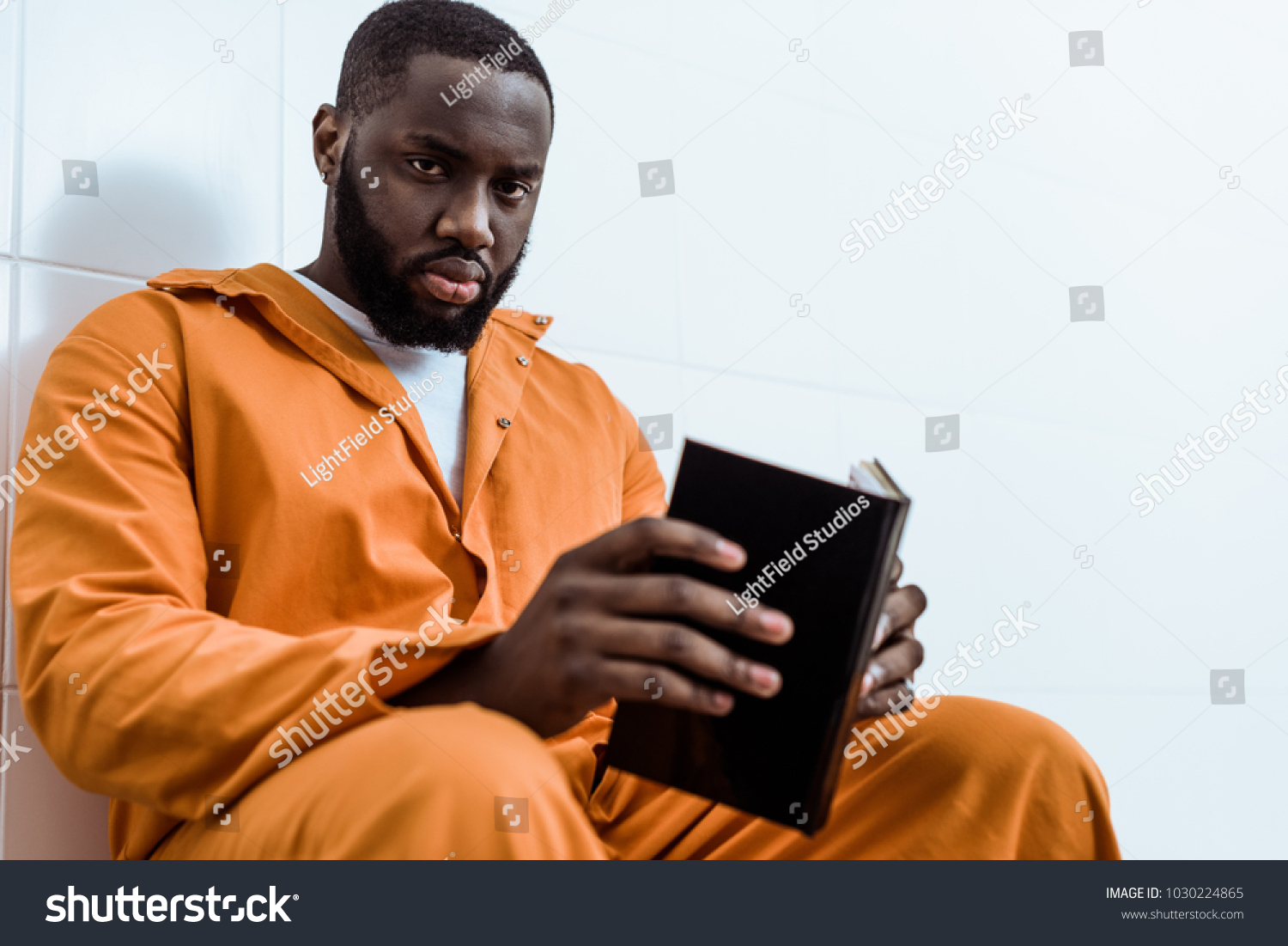 African American Prisoner Holding Book Looking Foto de stock 1030224865 ... African American Prisoner Holding Book Looking Foto de stock 1030224865 ...