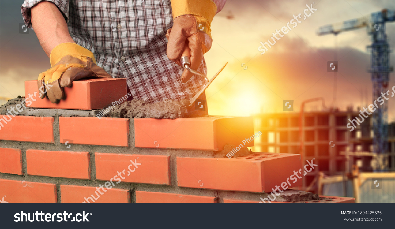 Bricklayer Lays Bricks On Architecture Background Stock Photo ...