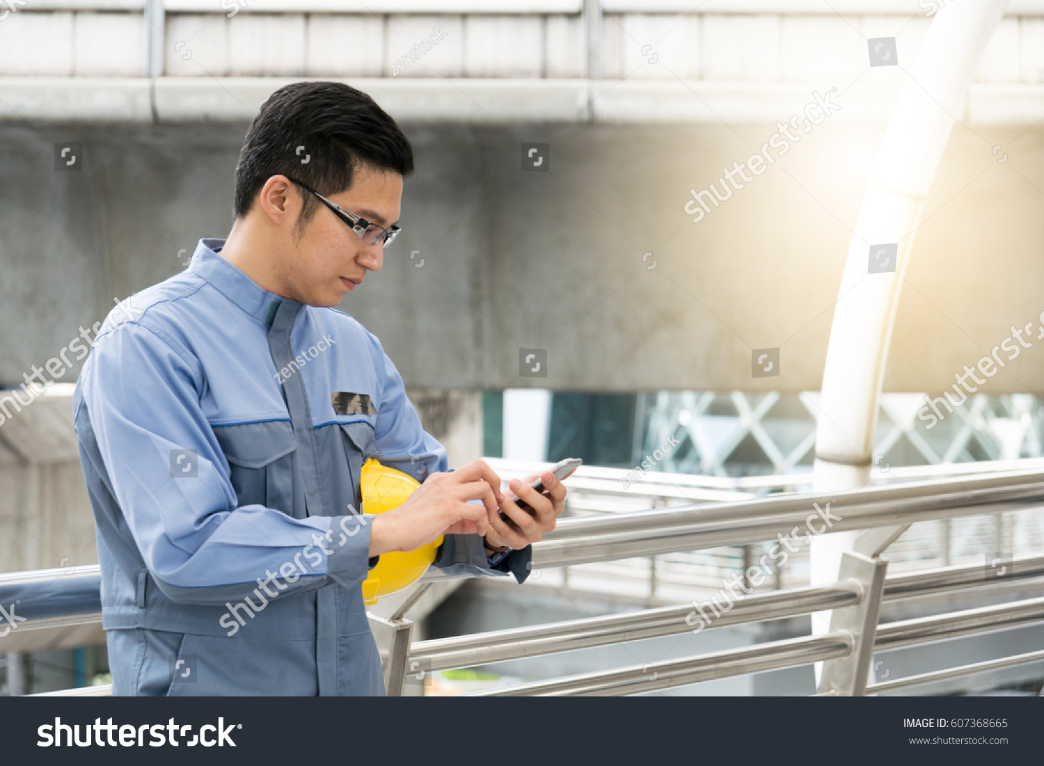 Engineer Using His Smartphone Stock Photo 607368665 - Shutterstock