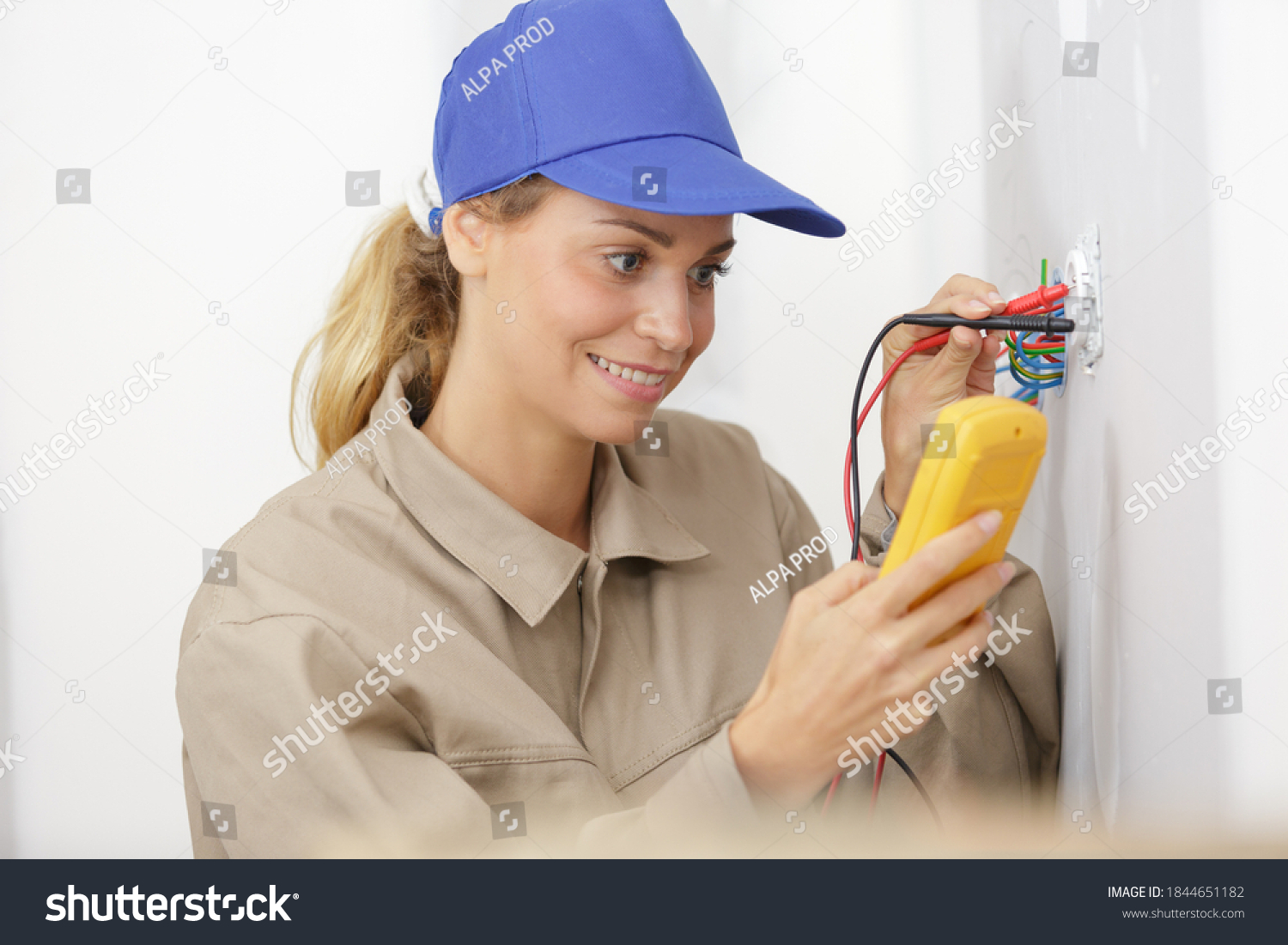 Female Electrician Testing Socket Using Multimeter Stock Photo ...