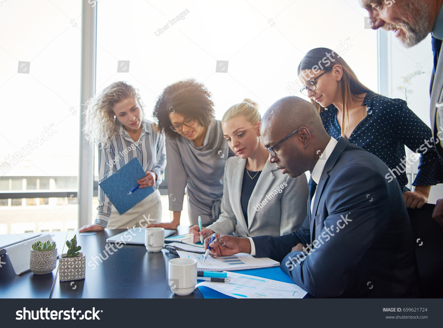 Group Focused Diverse Businesspeople Smiling Working Stock Photo (Edit ... Group Focused Diverse Businesspeople Smiling Working Stock Photo (Edit ...